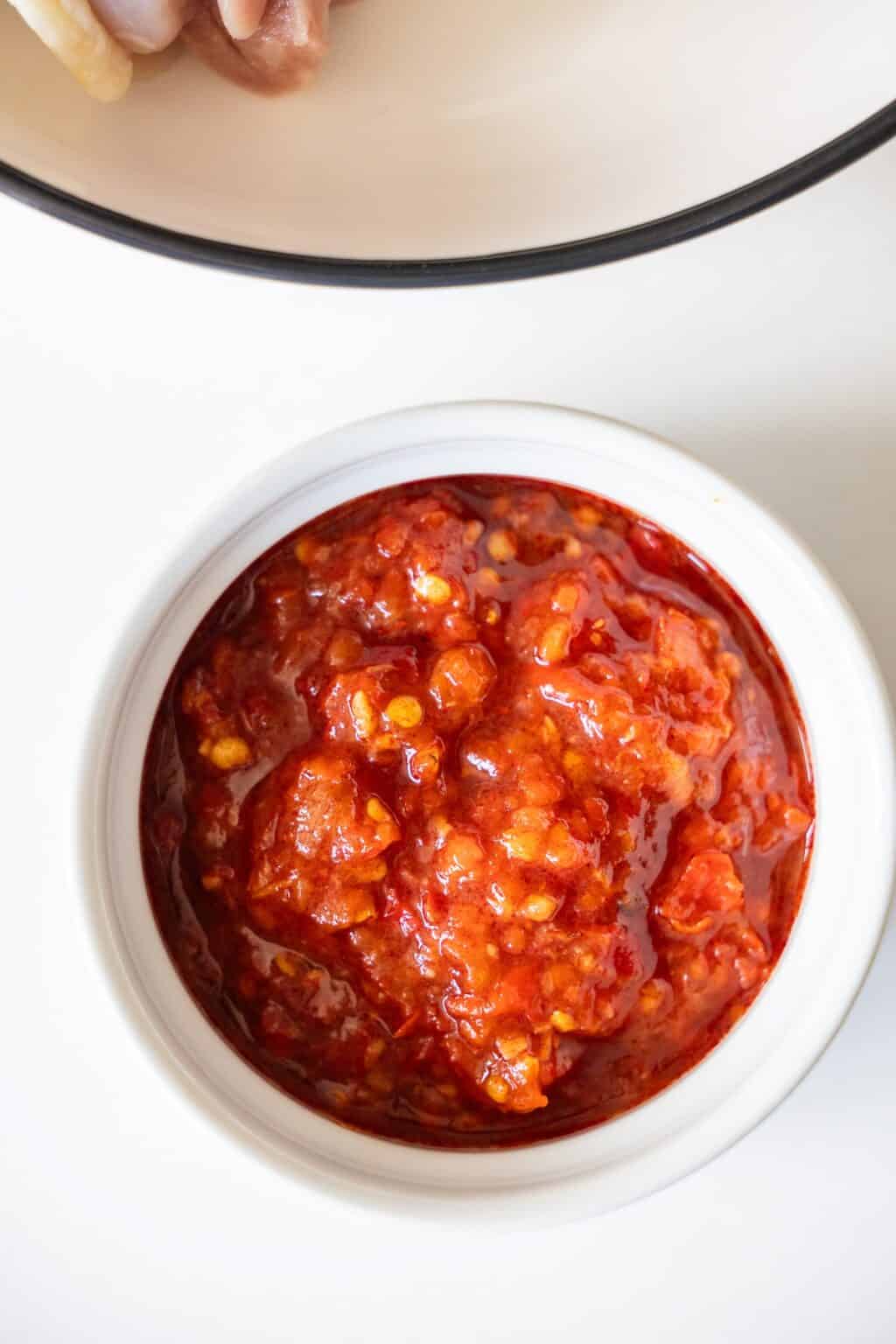 Spicy Harissa Chicken Thighs with Smashed Olives - Sweet Cs Designs